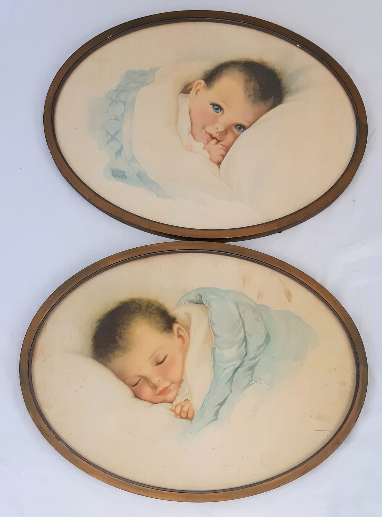 A PAIR OF 1930-40'S LILIAN ROWLES BABY PRINTS IN OVAL FRAMES. 43 X 33cms