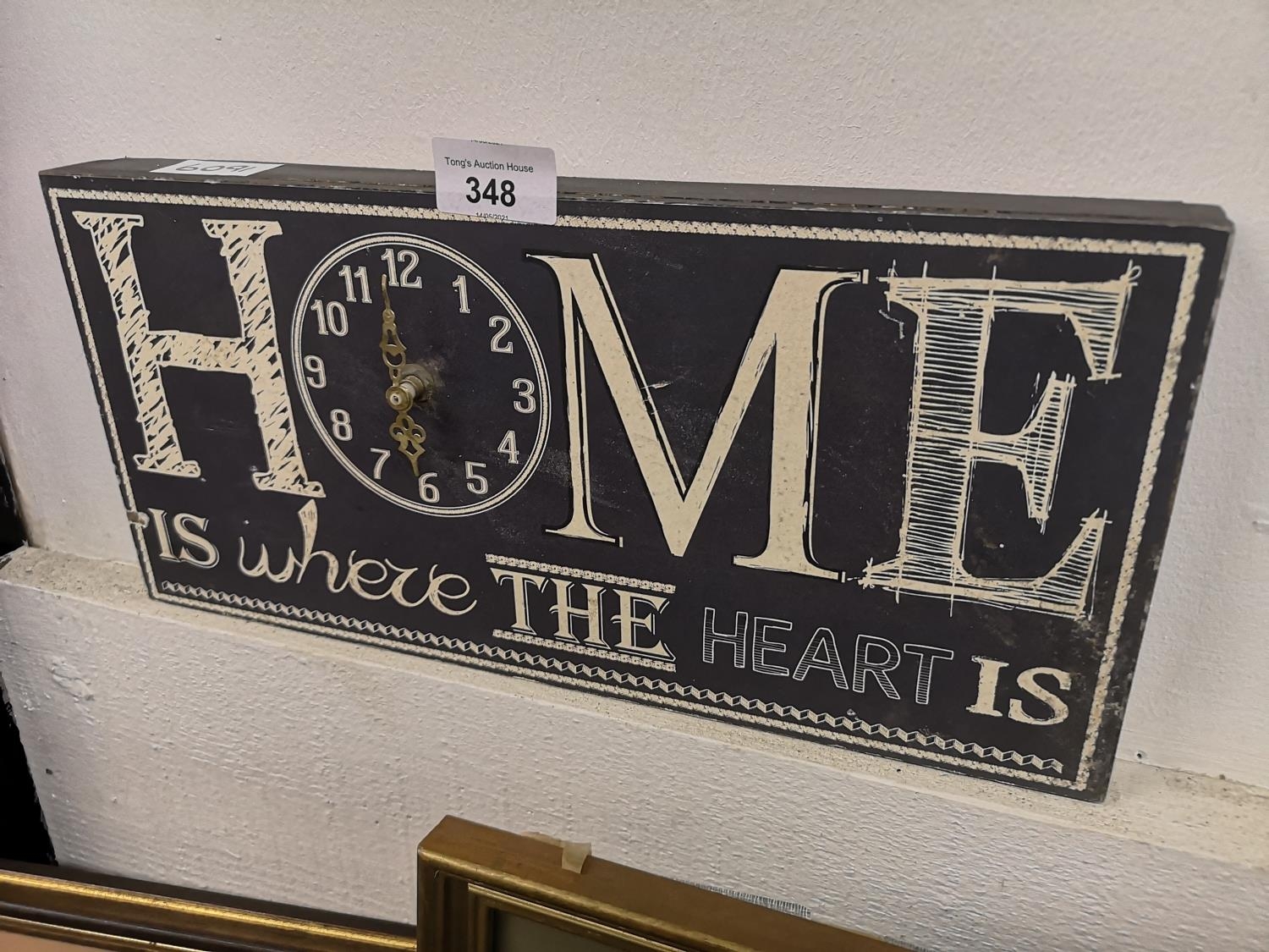 Wooden home sign with clock.