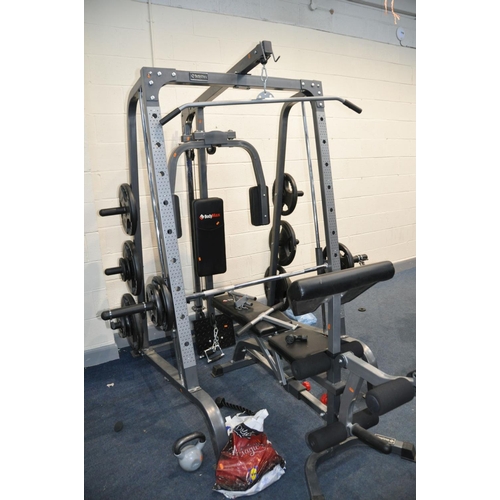 A BODYMAX CF380 SMITH MACHINE MULTI GYM with eighteen weight... | Barnebys