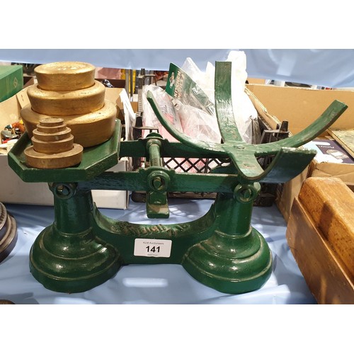 A set of vintage cast iron scales with weights.
