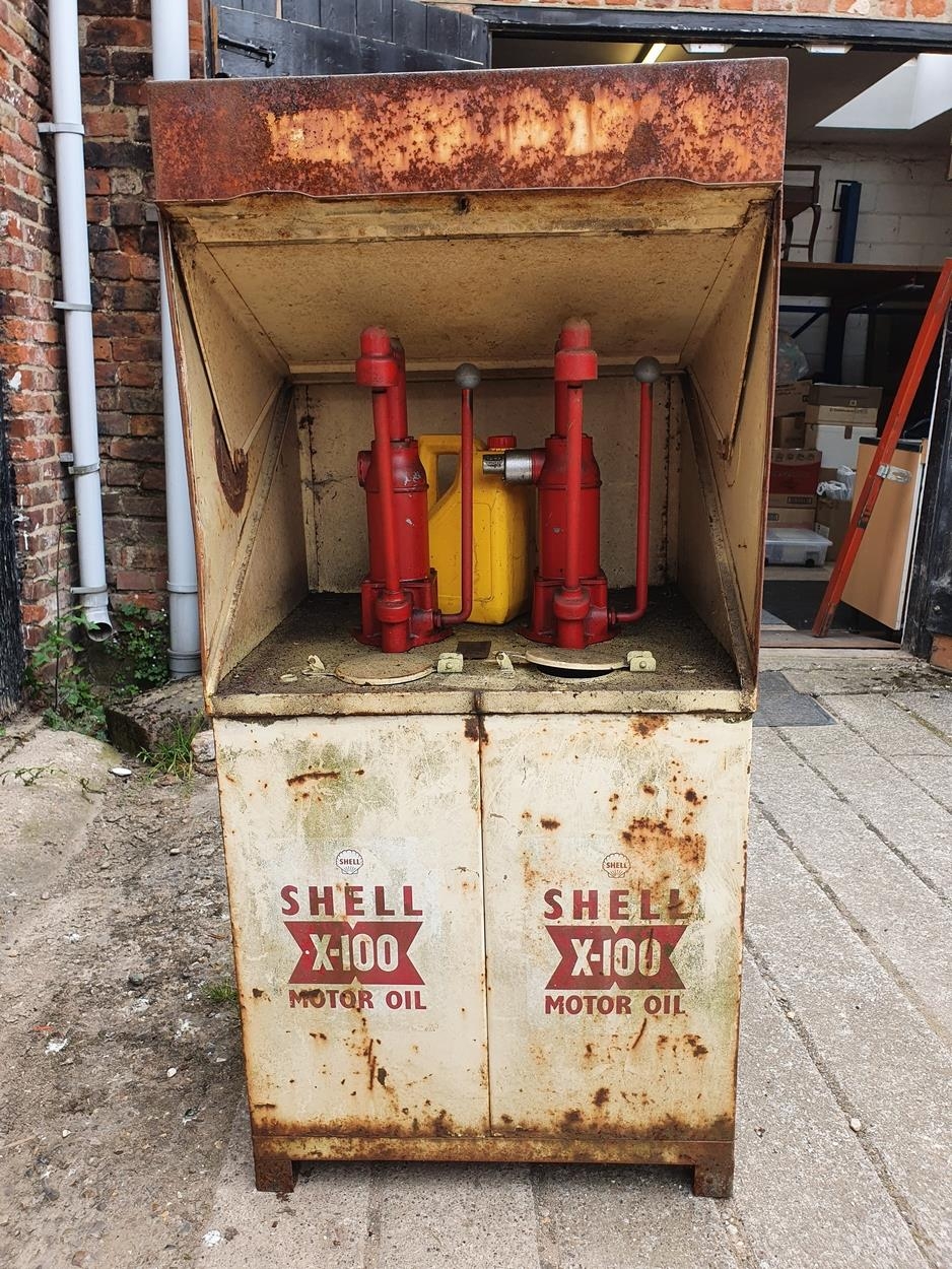 A vintage oil dispenser cabinet, painted in white with Shell X 100 oil ...