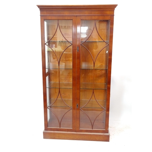 A reproduction yew wood display cabinet, with 2 lattice glaz... | Barnebys