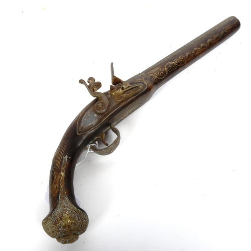 An Indian flintlock pistol with inlaid brass decoration, 43c... | Barnebys