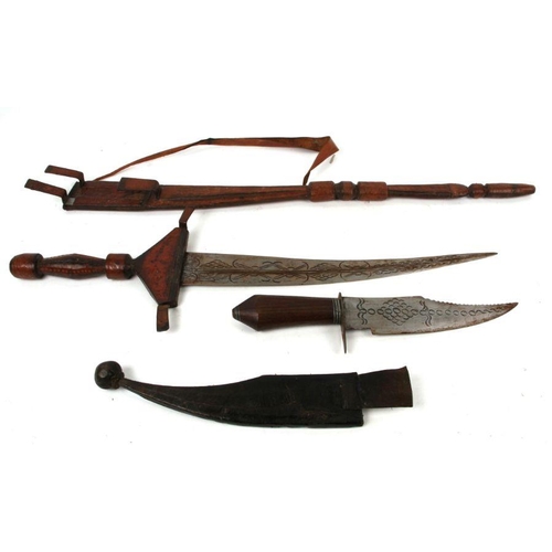 A North African sword in tooled leather scabbard with multip... | Barnebys