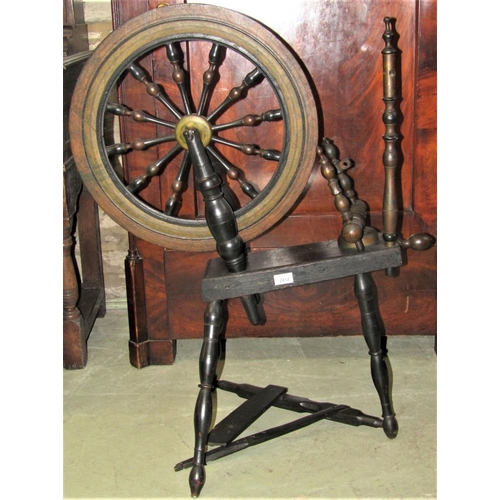 A traditional foot pedal operated spinning wheel, dark stain... | Barnebys
