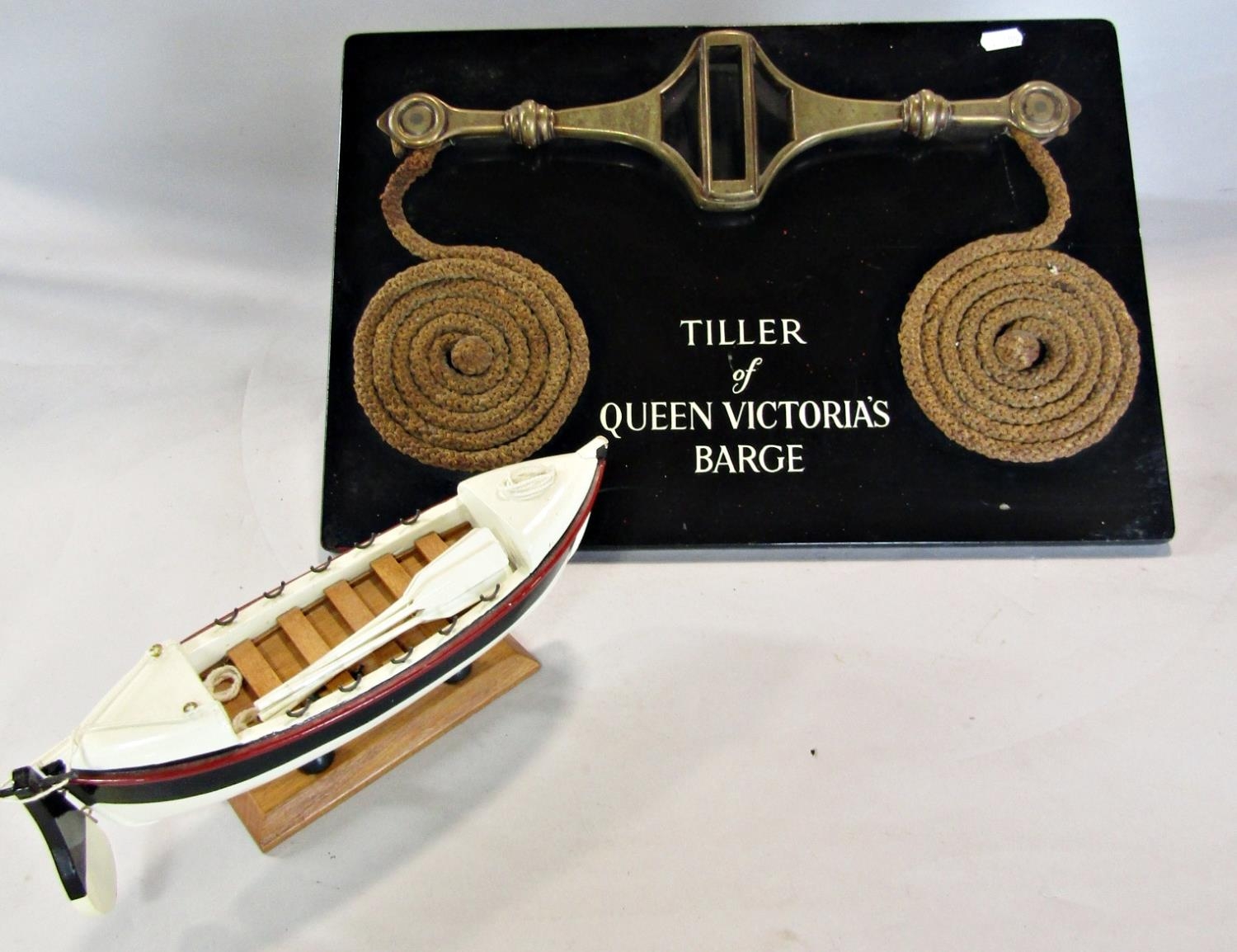A wall plaque of the brass tiller of - auctions & price archive