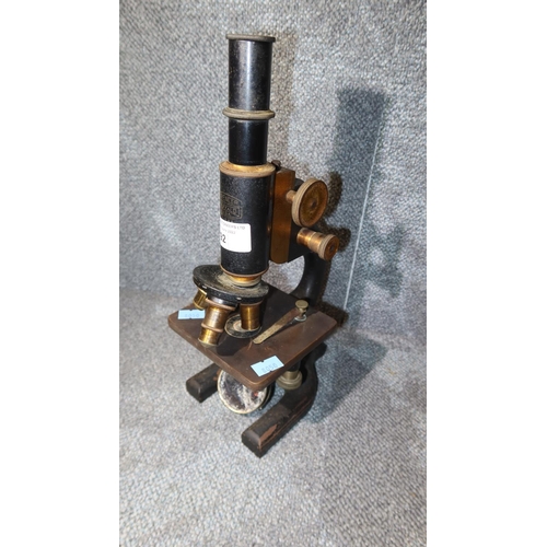 A vintage brass mounted cast iron microscope by Spencer Buffalo, USA