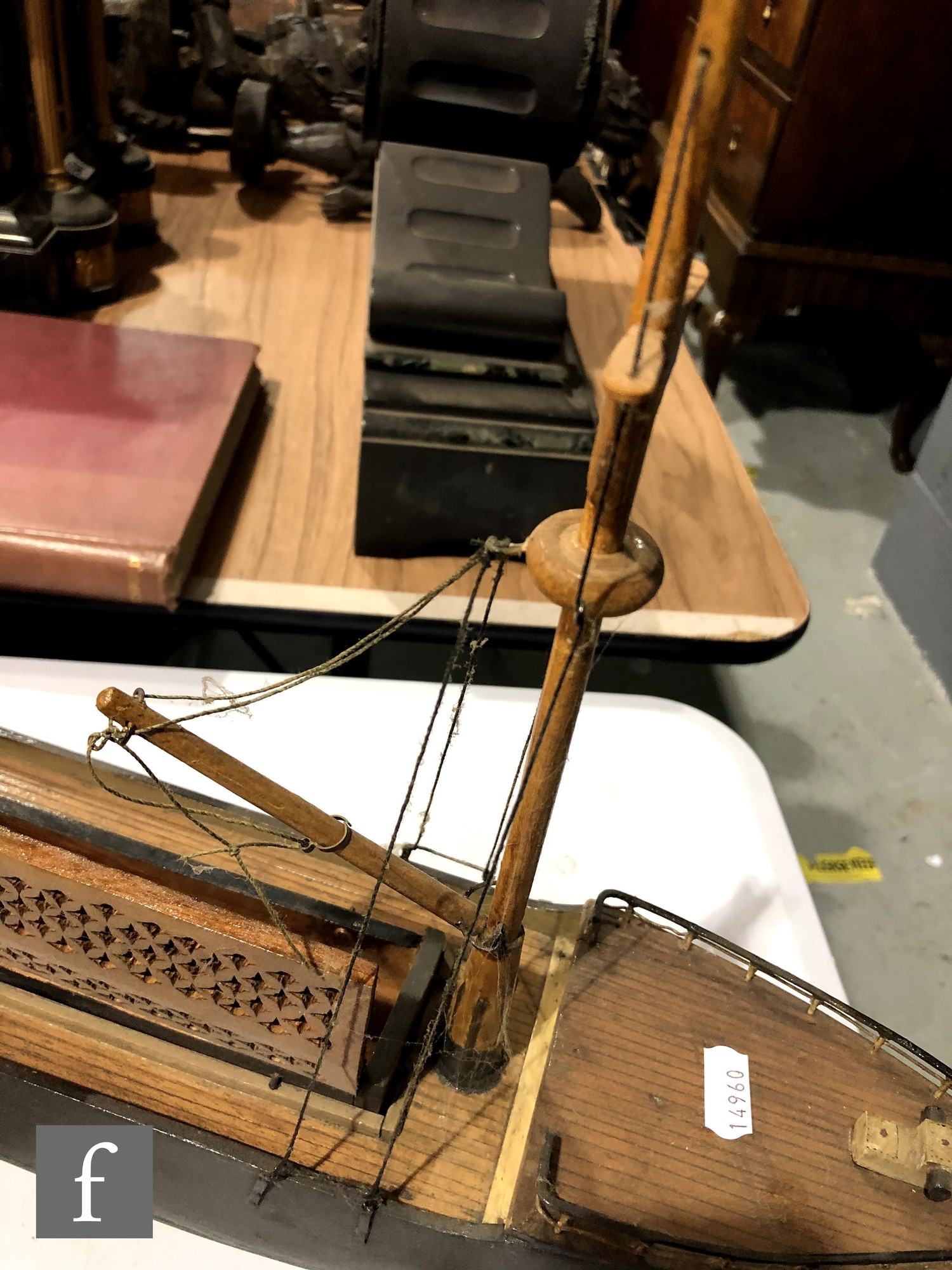 A well constructed wooden clockwork model of a cargo boat, length 75cm.