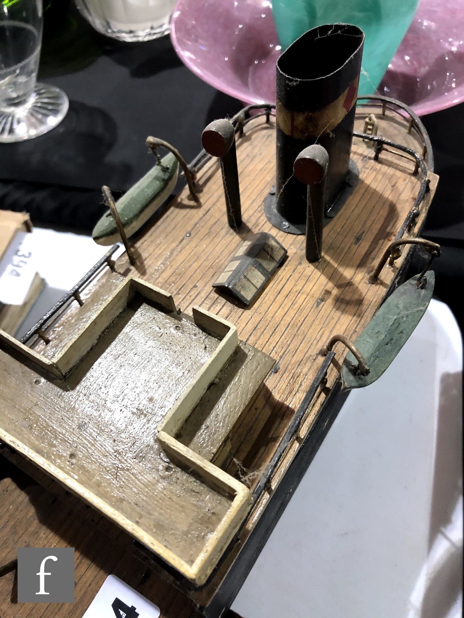 A well constructed wooden clockwork model of a cargo boat, length 75cm.
