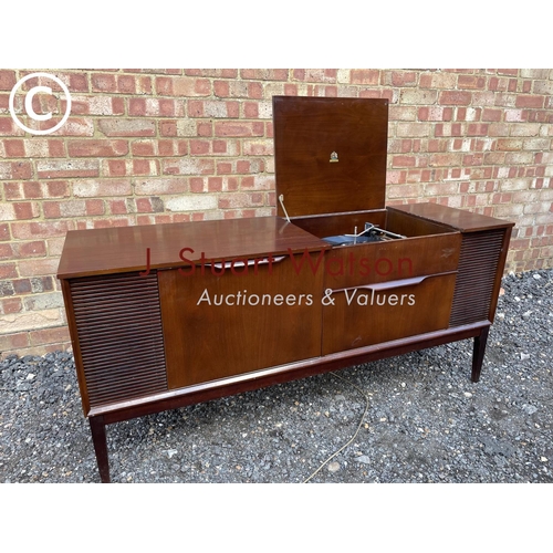 A mid century teak radiogram fitted with a garrard record de... | Barnebys