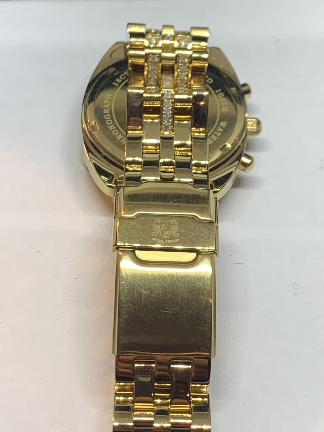 AN ASTON GERARD GOLD PLATED WATCH WITH DIAMONDS IN A PRESENTATION BOX