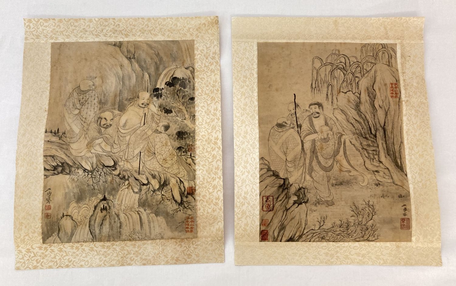 A pair of signed Chinese prints on fabric depicting figural scenes ...