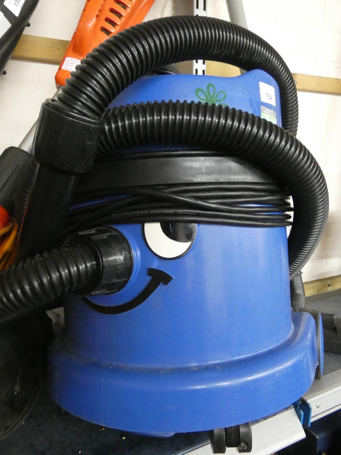 A blue numatic Henry style vacuum cleaner with tools