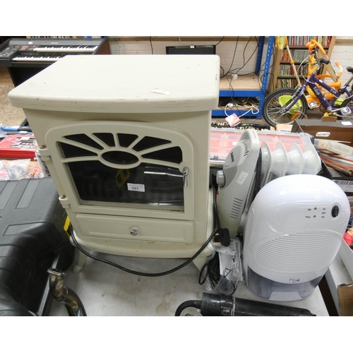 An electric log burning style convector heater, a small radi... | Barnebys