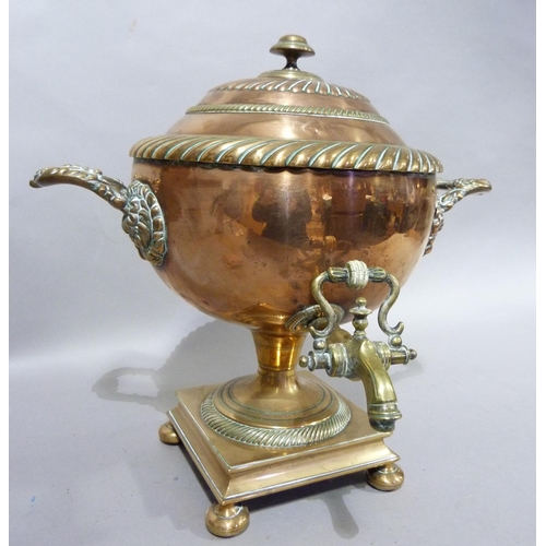 A 19th century copper two handled tea urn with domed and fluted cover ...