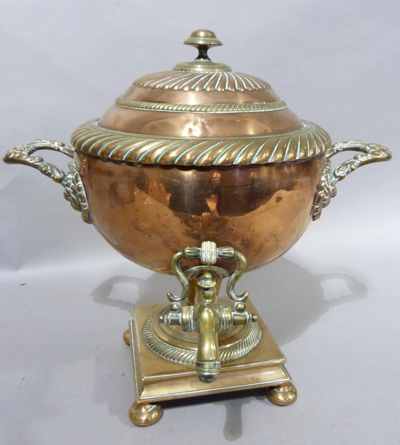 A 19th century copper two handled tea urn with domed and fluted cover ...