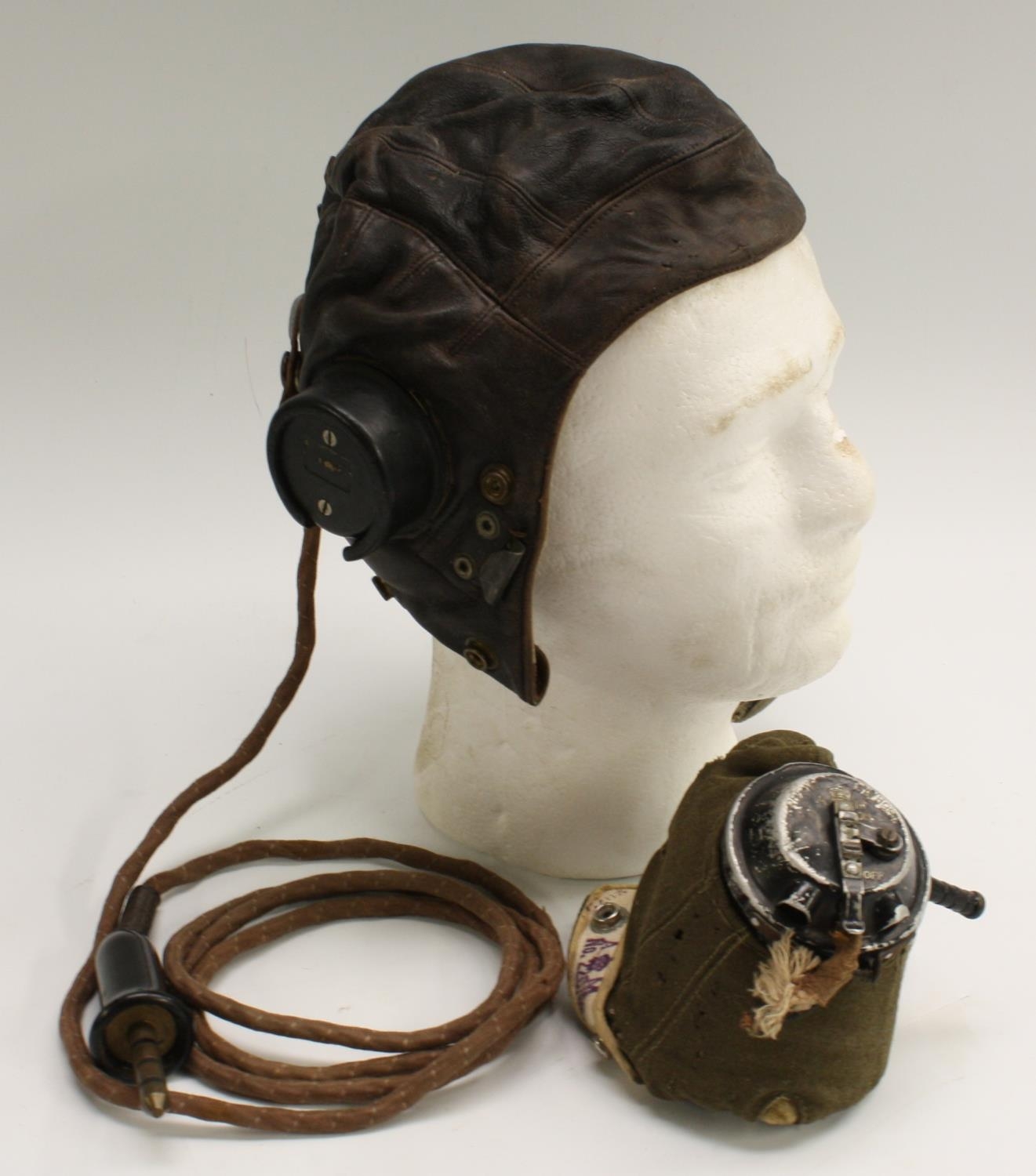 An Air Ministry issue brown leather flying helmet, chamois lined ...