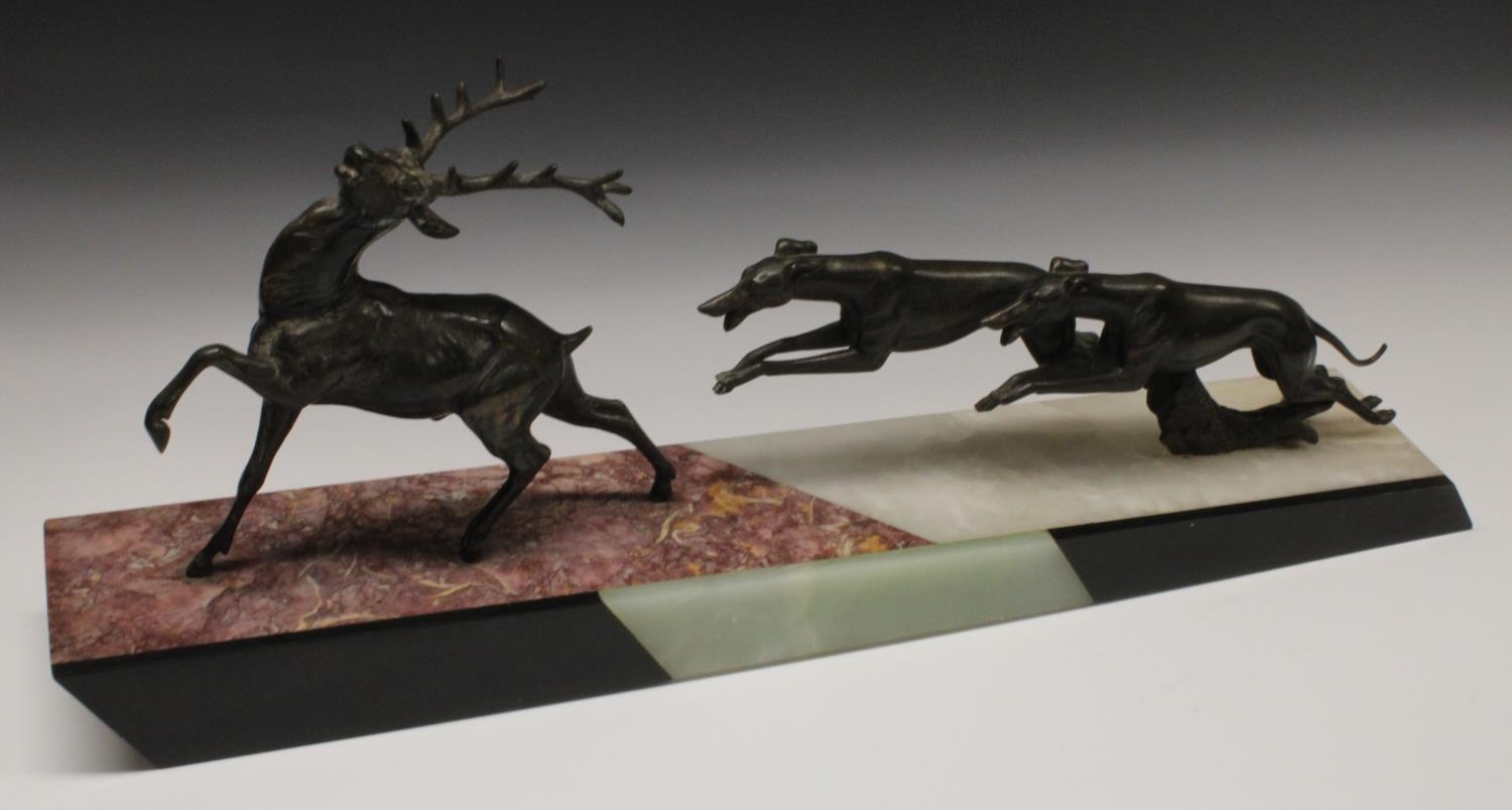 Art Deco, a spelter group, of a stag being chased by two greyhounds ...