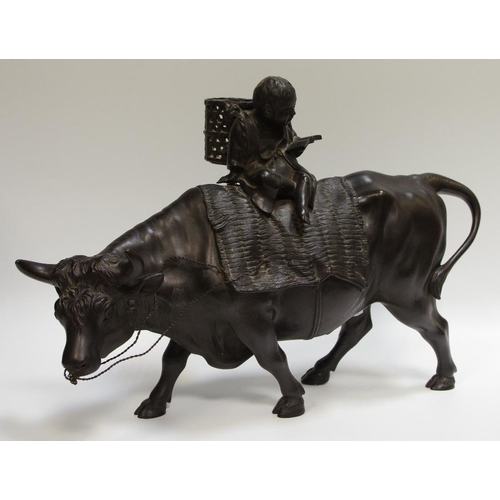 A Chinese bronze boy riding a bull, 44cm long