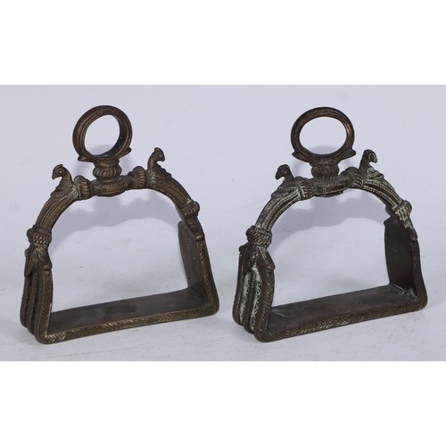 A pair of Mughal Indian bronze stirrups, cast in the Islamic... | Barnebys