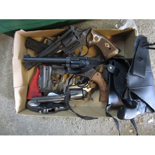 A box of plastic revolver type toy pistols including a pistol in a ...