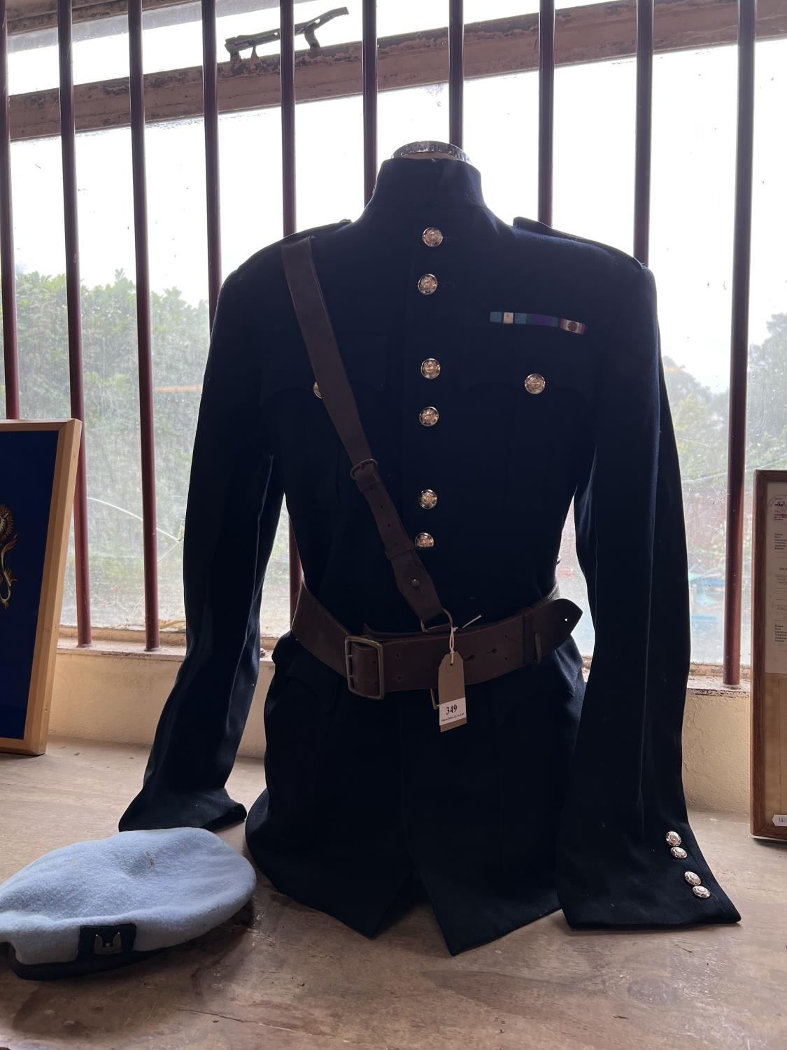 A military uniform, webbing and beret