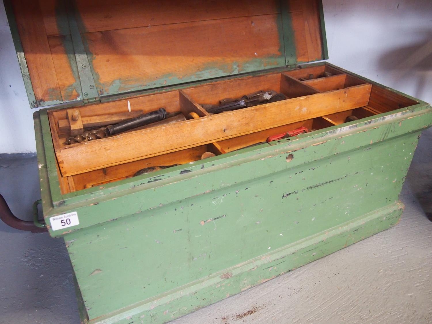 A wooden carpenter's box with two internal trays, filled with a ...