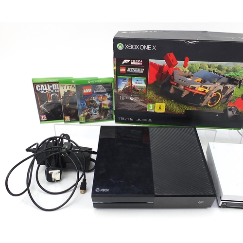 Xbox One X games console and Xbox One S games console with controllers ...