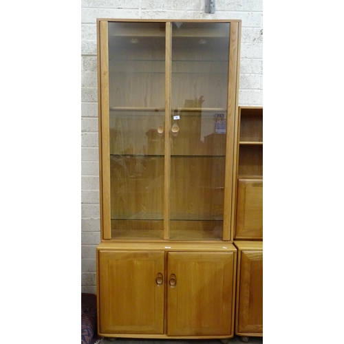 A modern Ercol light elm display cabinet, the upper section ... | Barnebys