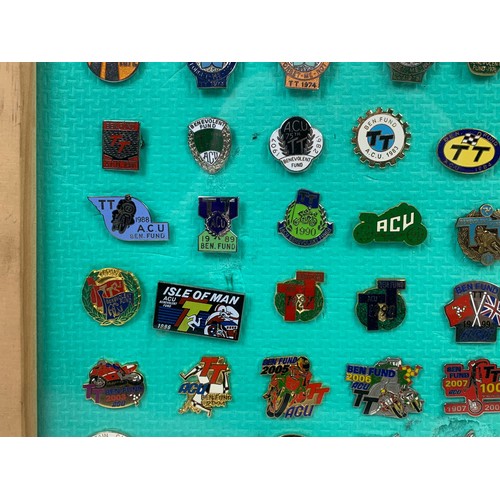 A collection of framed TT racing badges. Frame measures 36 x 36cm